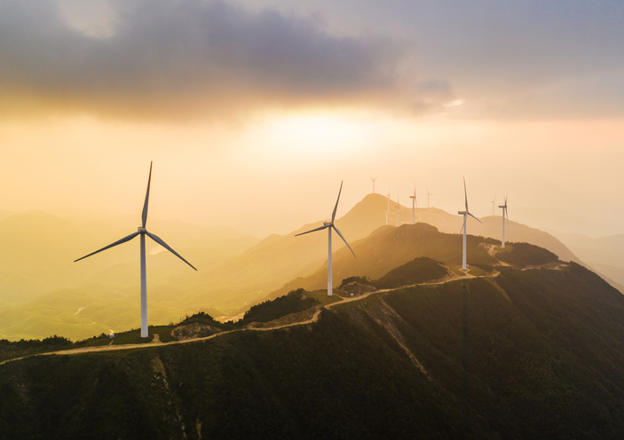 Wind farm on mountain ridge. High angle of view aerial shot. | BankingHub